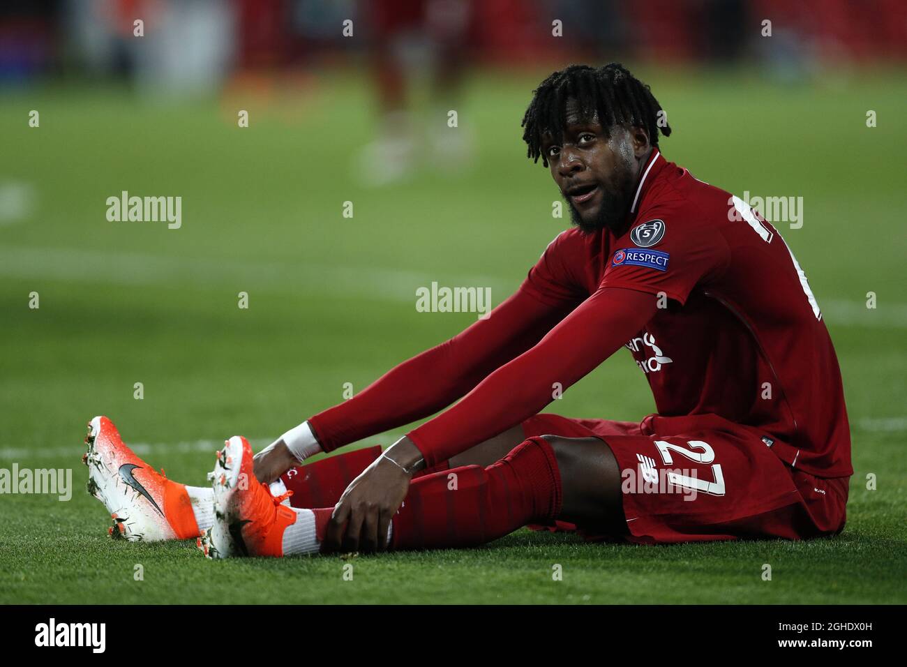 Liverpool's Divock Origi looks on as he goes off injured during the ...