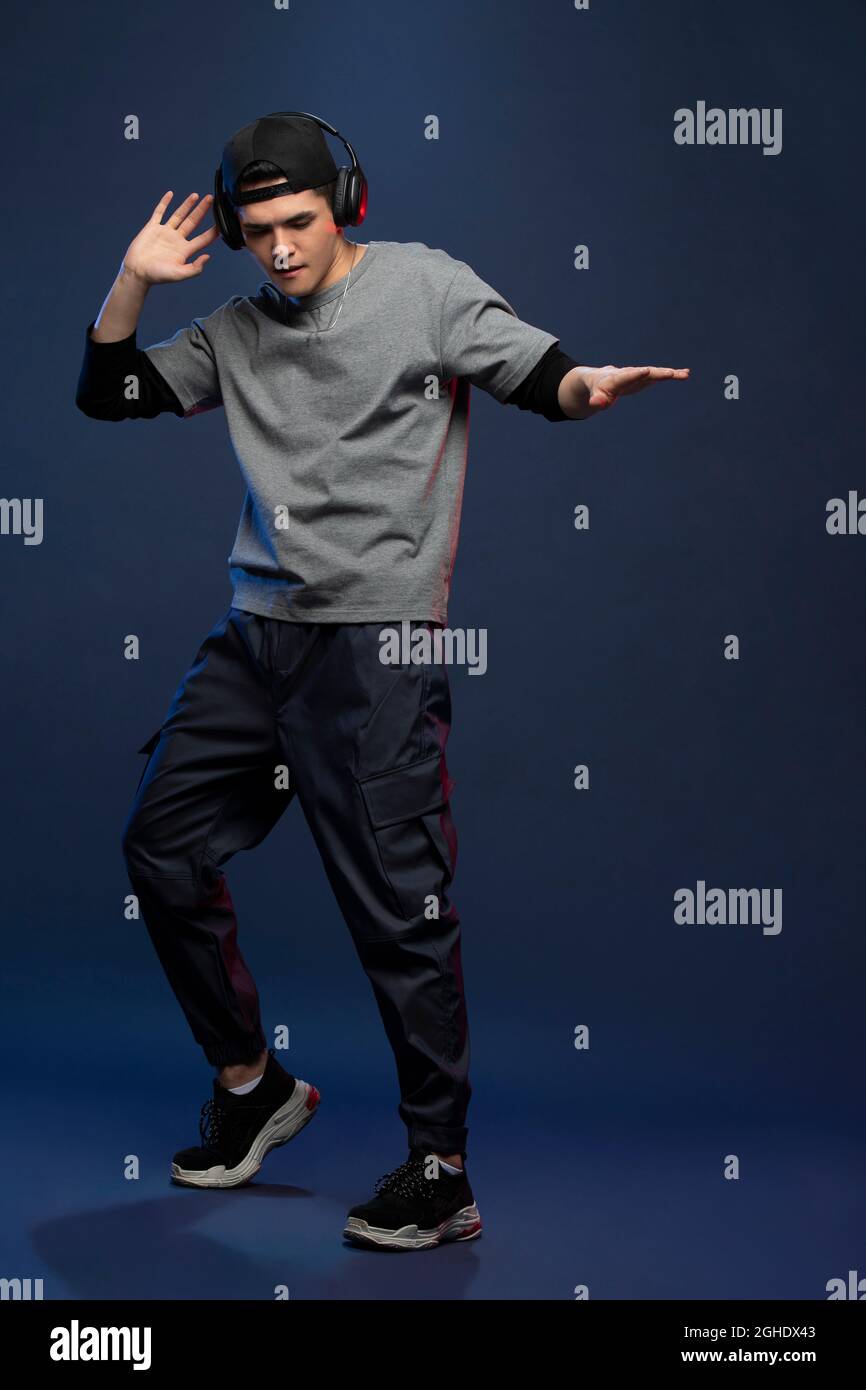 Studio shot of fashionable young man dancing Stock Photo - Alamy