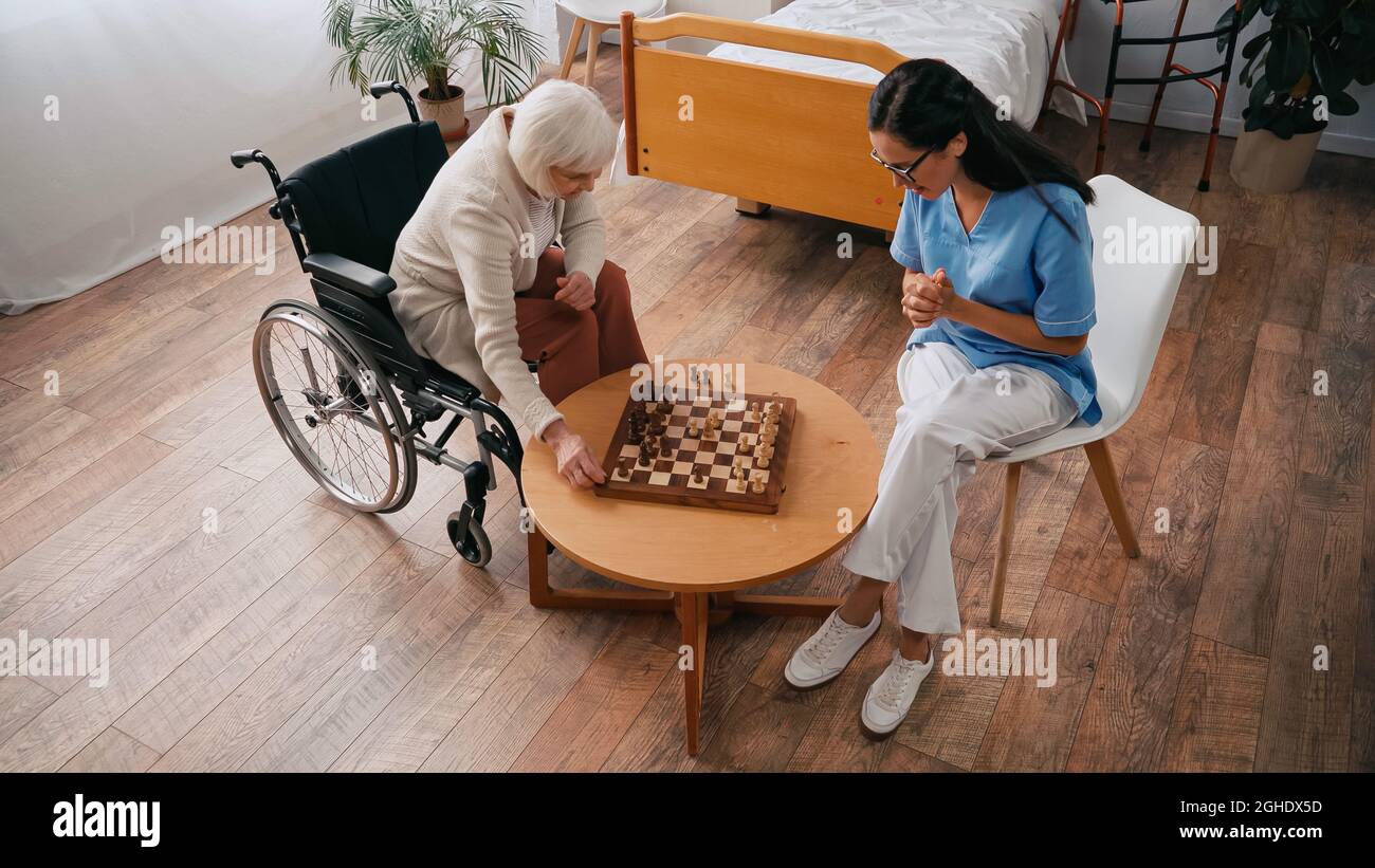 Elderly woman nurse playing board hi-res stock photography and images ...