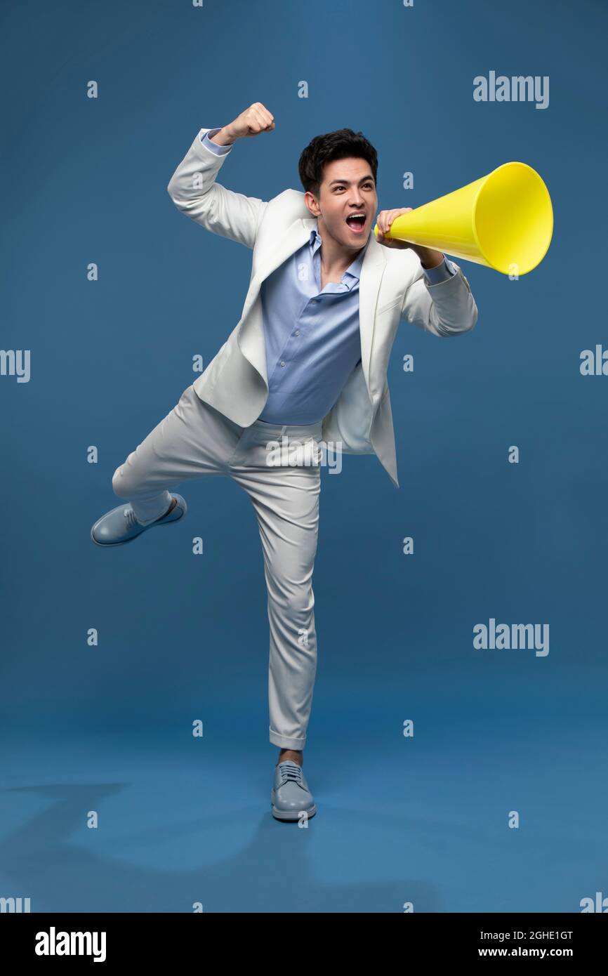 Smiling handsome man megaphone hi-res stock photography and images - Alamy