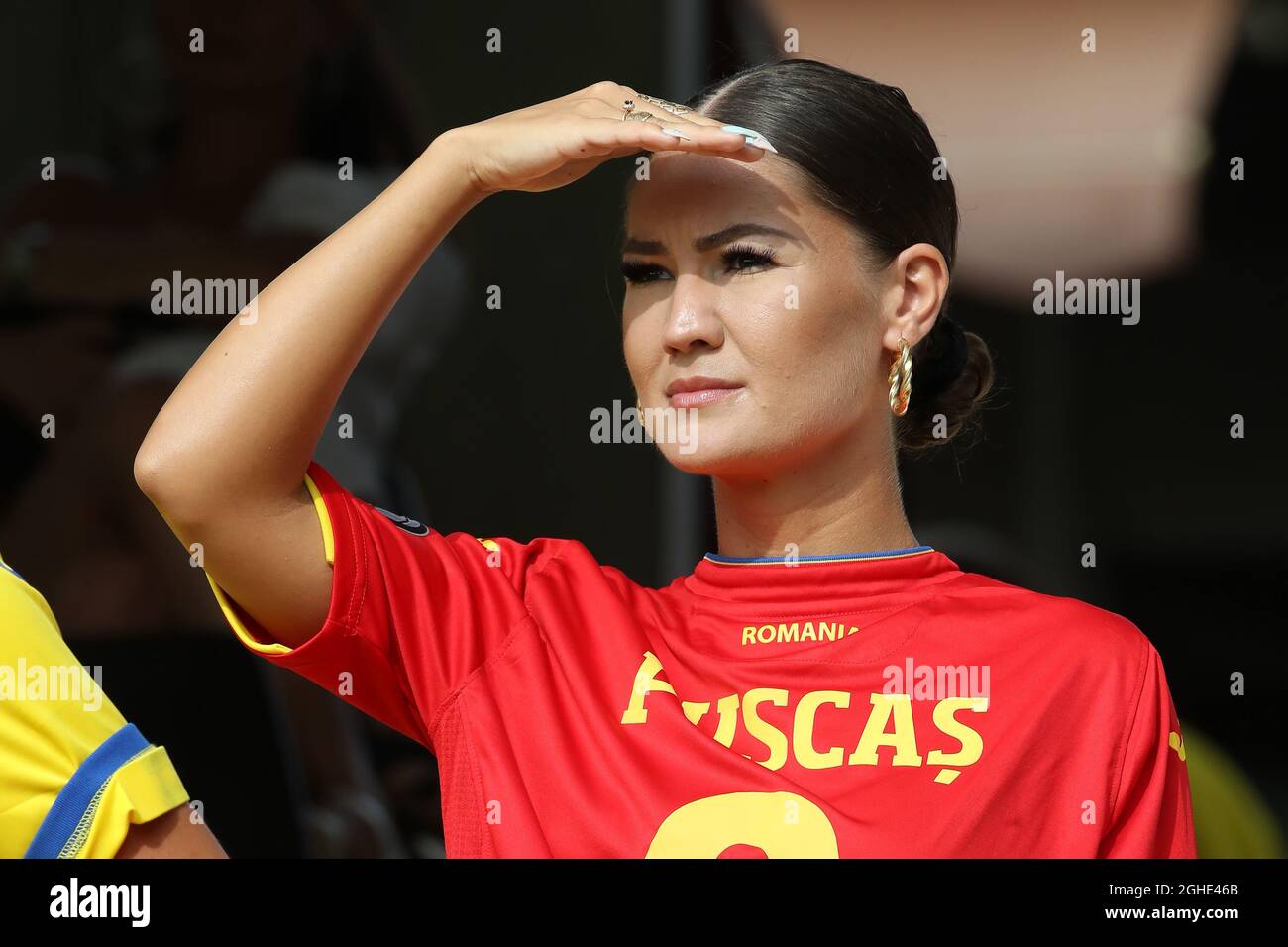 A female Romania fan pictured wearing a shirt bearing the name Puskas ...