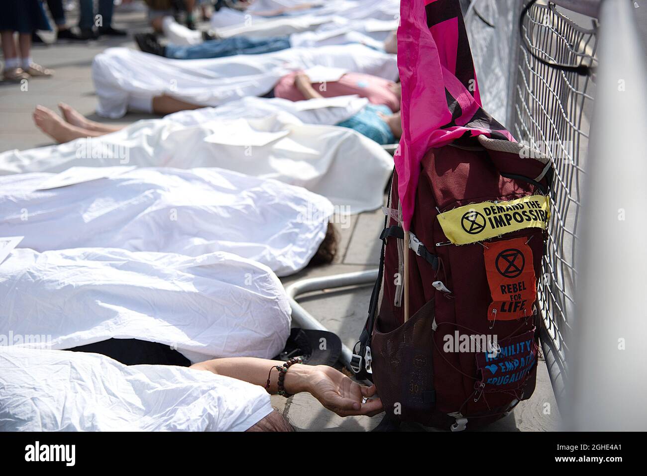 Activists participate in a "Die-In" while laying down on the sidewalk ...