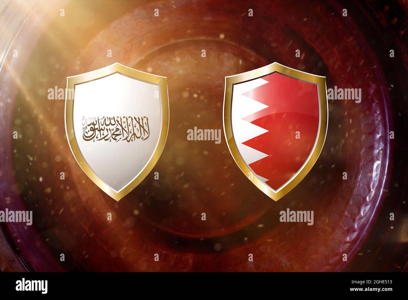 taliban and bahrain flag in golden shield on copper texture background ...
