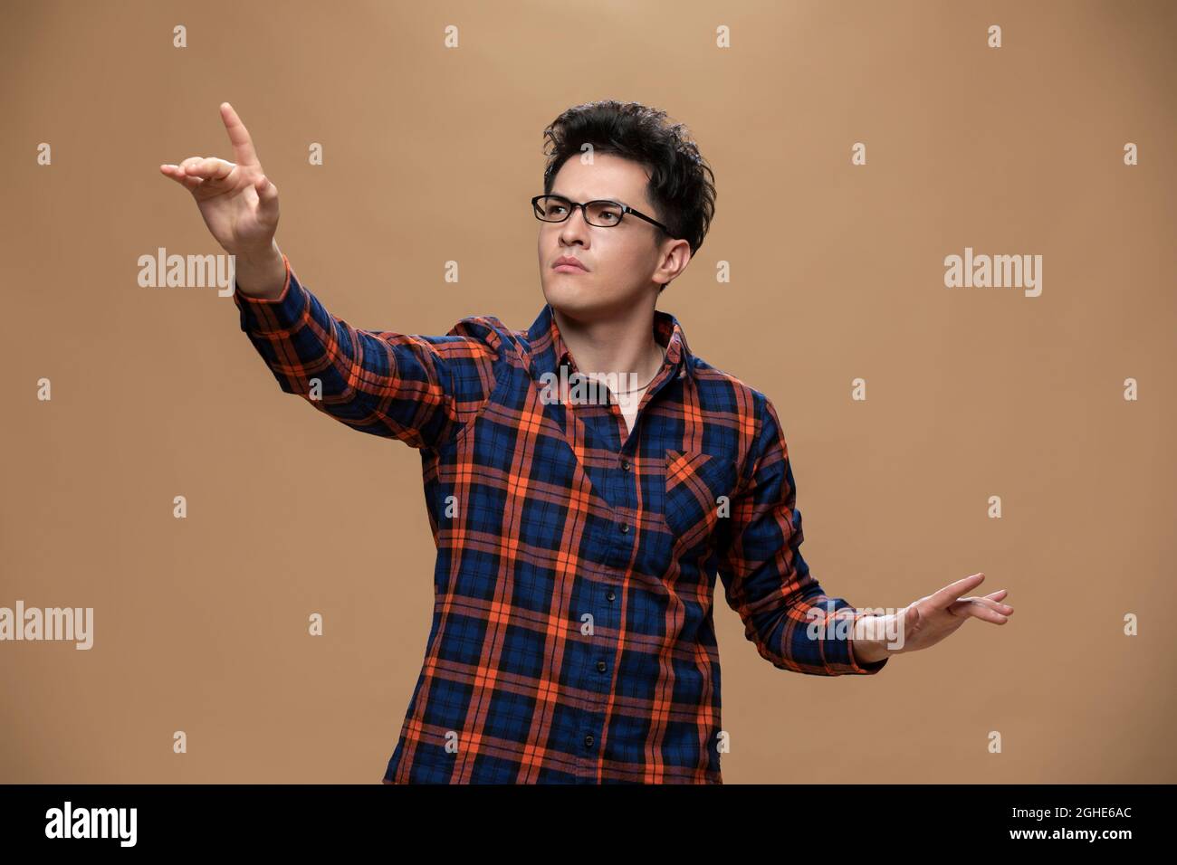 Studio shot of young man pointing Stock Photo - Alamy