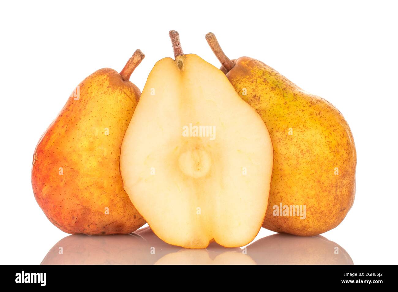 Two whole and half sweet red pears, close-up, on a white background ...