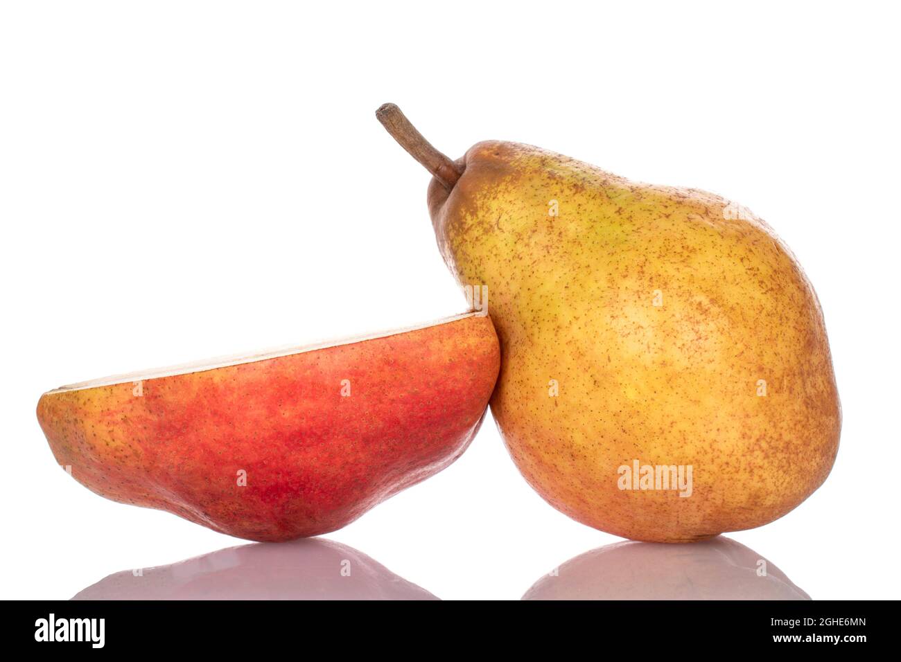 One whole and half of ripe red pears, close-up, on a white background ...