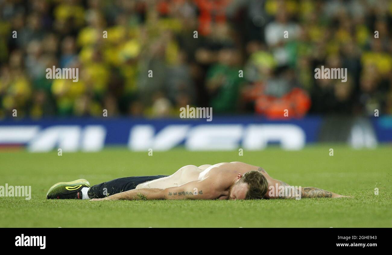 A streaker interrupts play during a substitution during the Premier ...