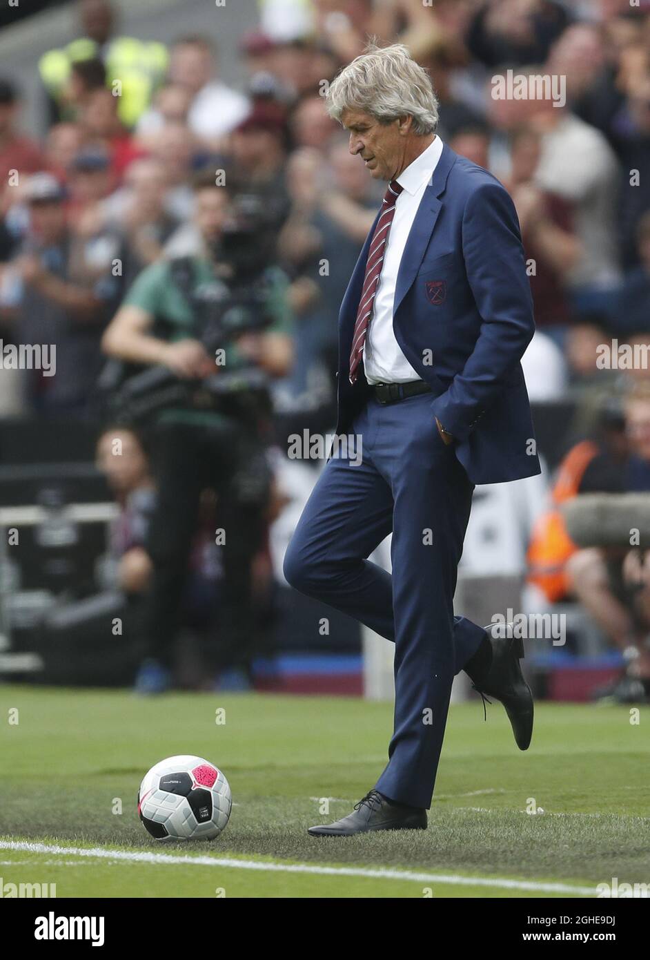 Manuel Pellegrini manager of West Ham United controls the ball during ...