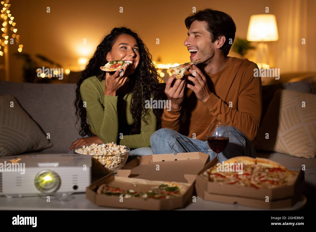 Couple Eating Pizza Watching Film Using Home Cinema Projector Indoor ...