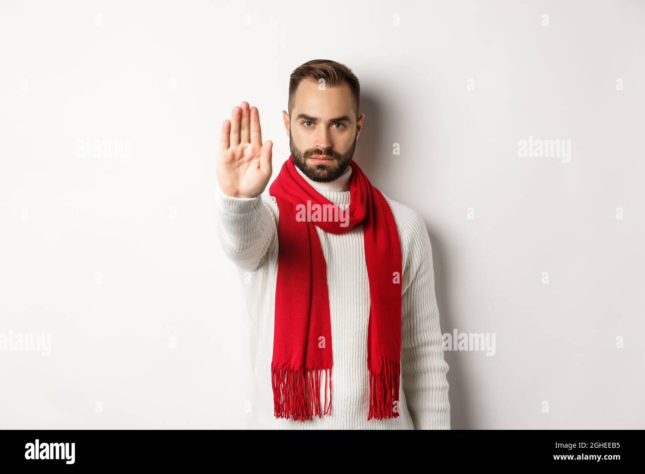 Serious bearded guy saying no, showing stop sign, rejection sign ...