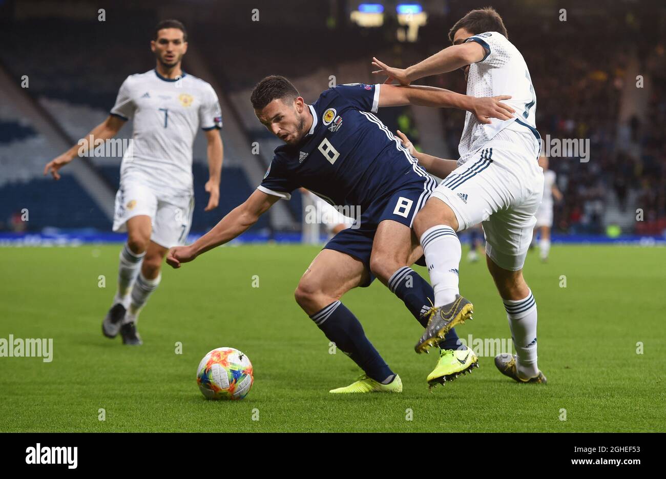 John McGinn of Scotland and Georgi Dzhikiya of Russia during the ...