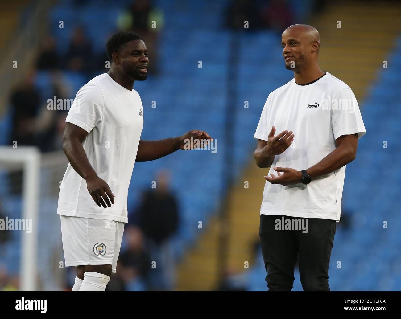 Micah Richards (l) chats to Vincent Kompany during the Vincent Kompany ...