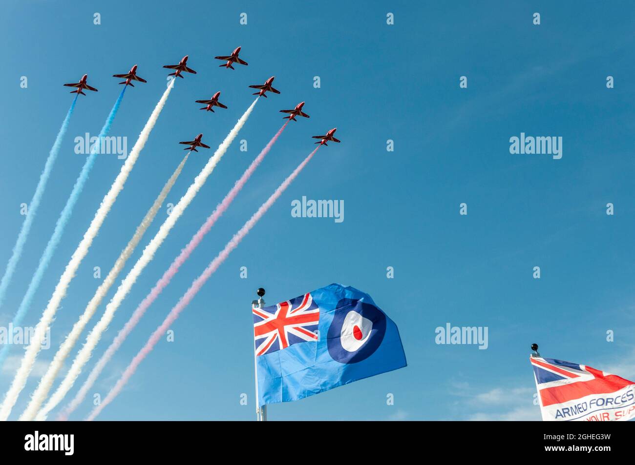 RAF Royal Air Force Red Arrows jet planes flying over RAF ensign flag ...