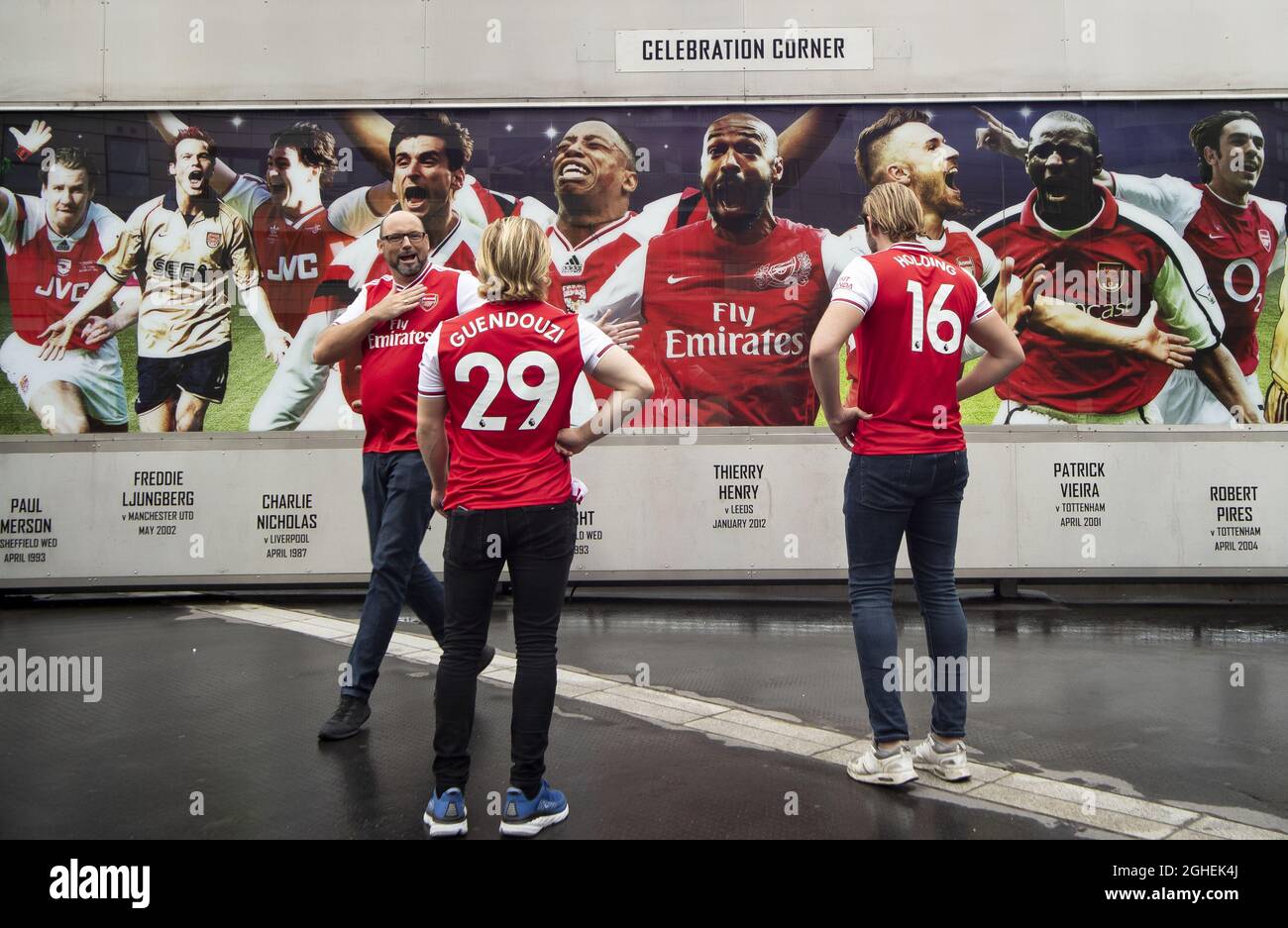Three Arsenal fans look at the 'Celebration Corner' outside of the ...