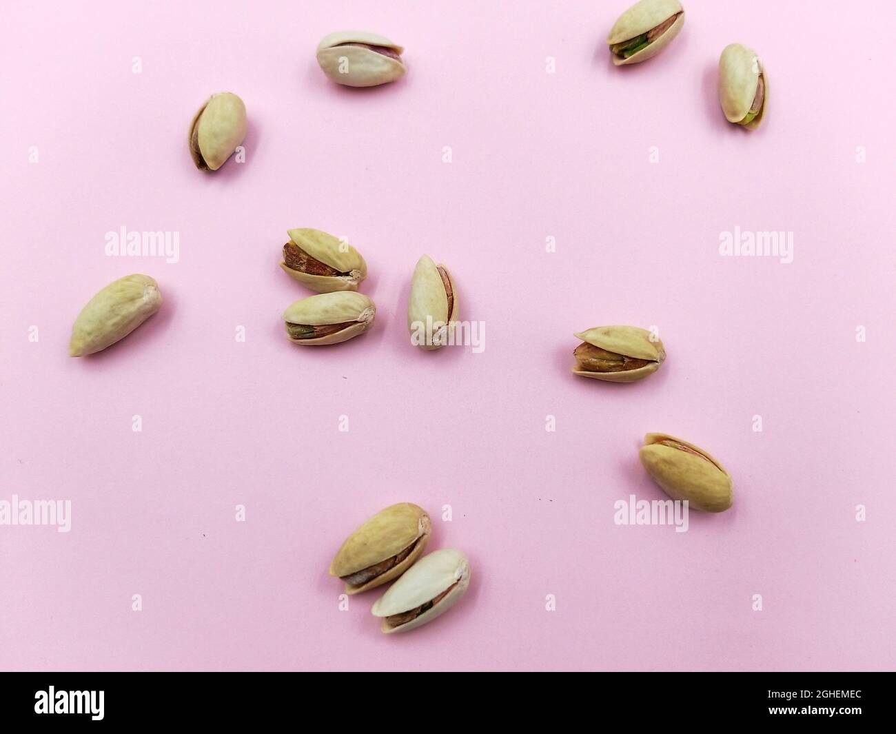 Top view of Roasted salted pistachio nuts isolated on a pink background Stock Photo - Alamy