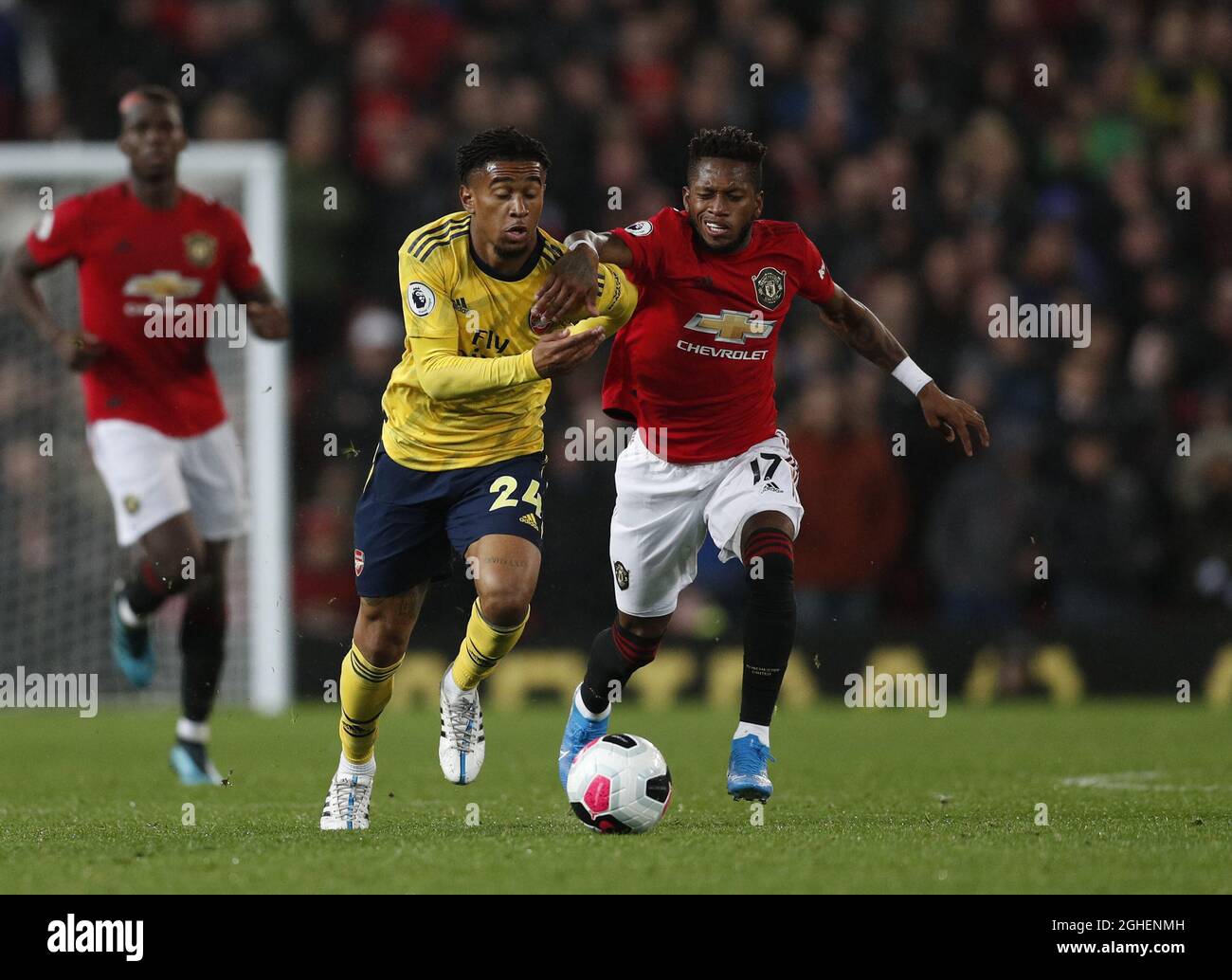 Reiss Nelson of Arsenal gets ahead of Fred of Manchester United during ...