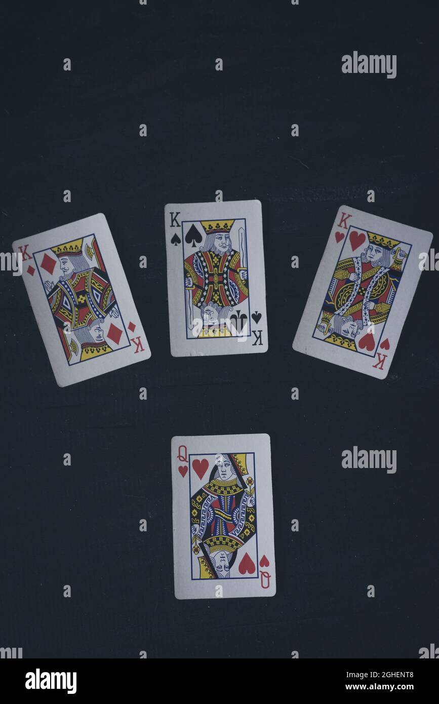 Vertical shot of King and Queen playing cards on an isolated black ...