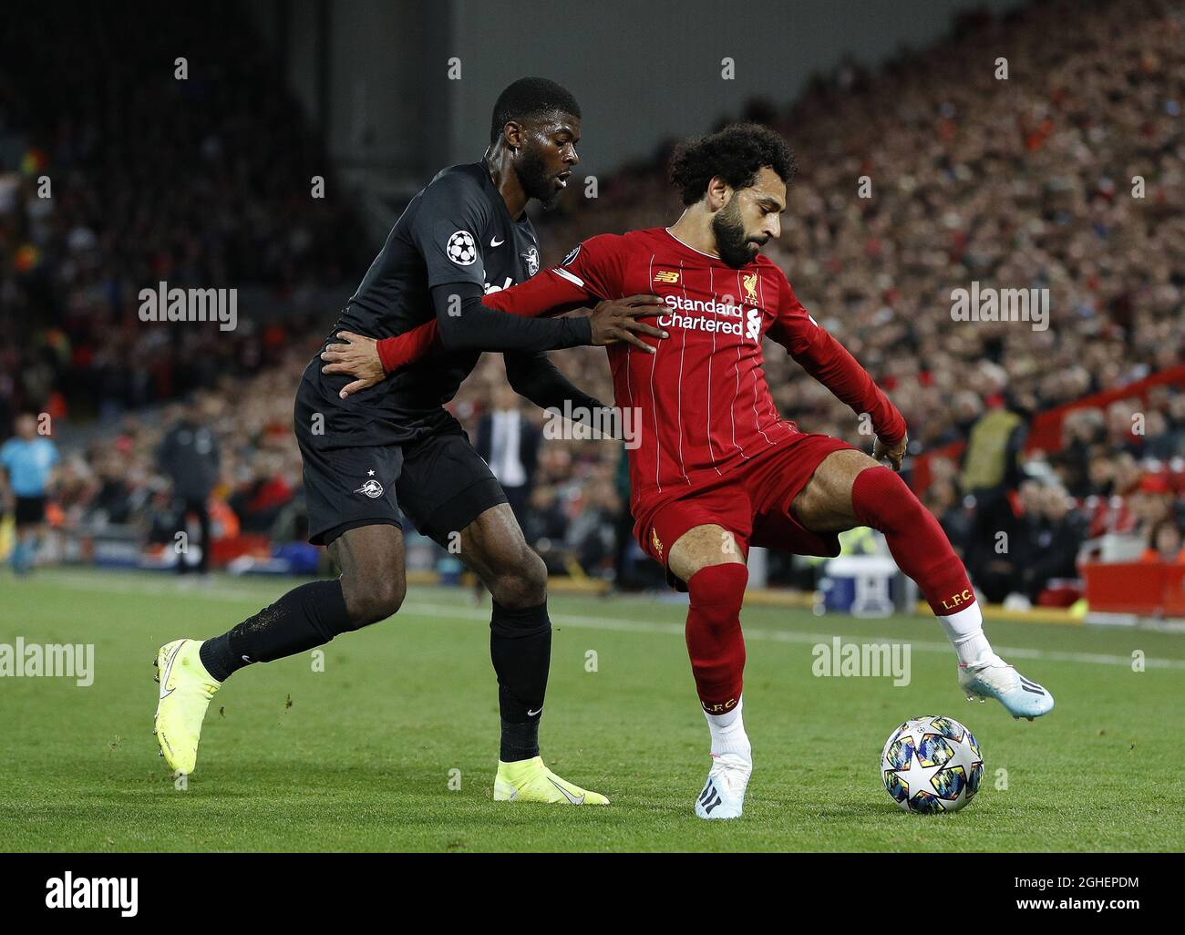 Mohamed Salah of Liverpool holds off Jerome Onguene of Salzburg during ...