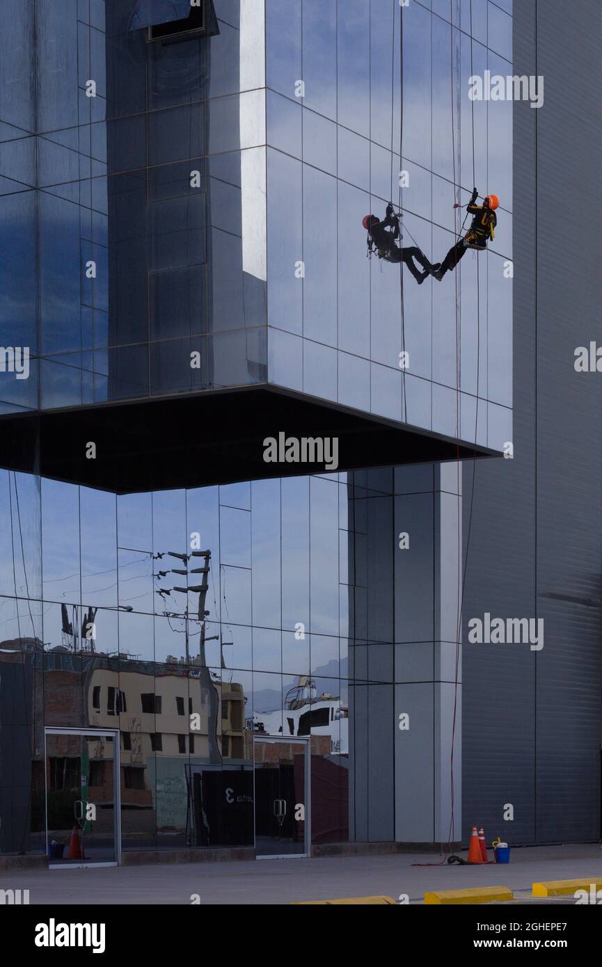 Person climbing glass wall hi-res stock photography and images - Alamy