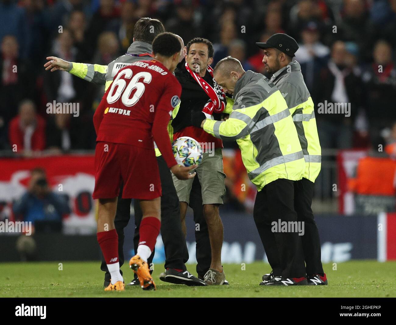 Stewards remove a pitch invader as Liverpool play Salzburg in the UEFA ...