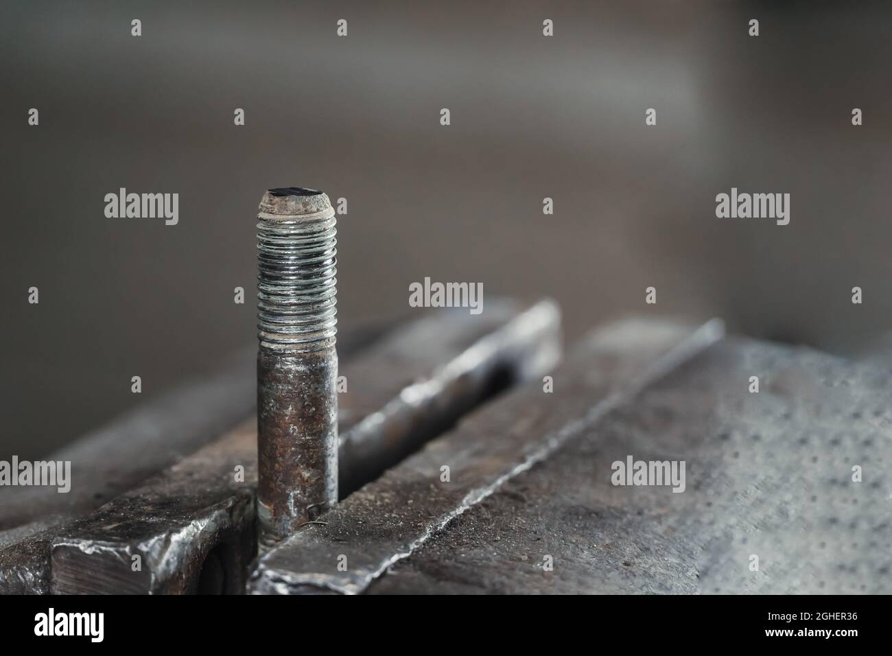 Close-up of a bolt in a metal clip in a garage workshop Stock Photo - Alamy