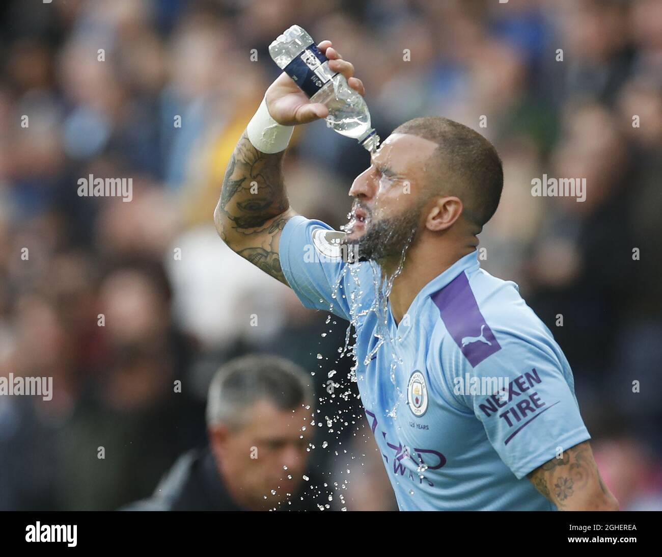 Kyle Walker of Manchester City covers his face with water during the ...