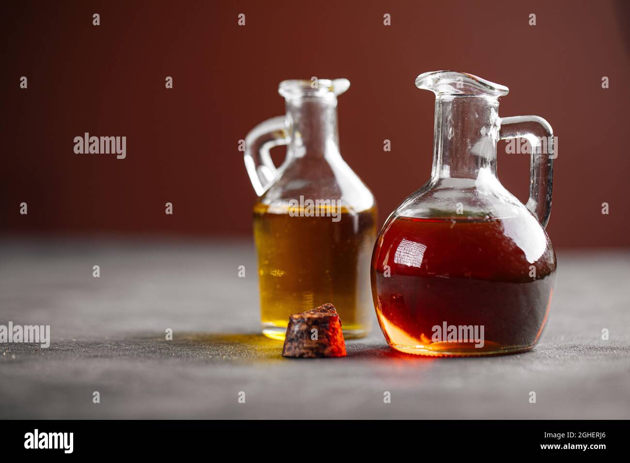 Side view on two lass jugs with oil for cooking Stock Photo - Alamy