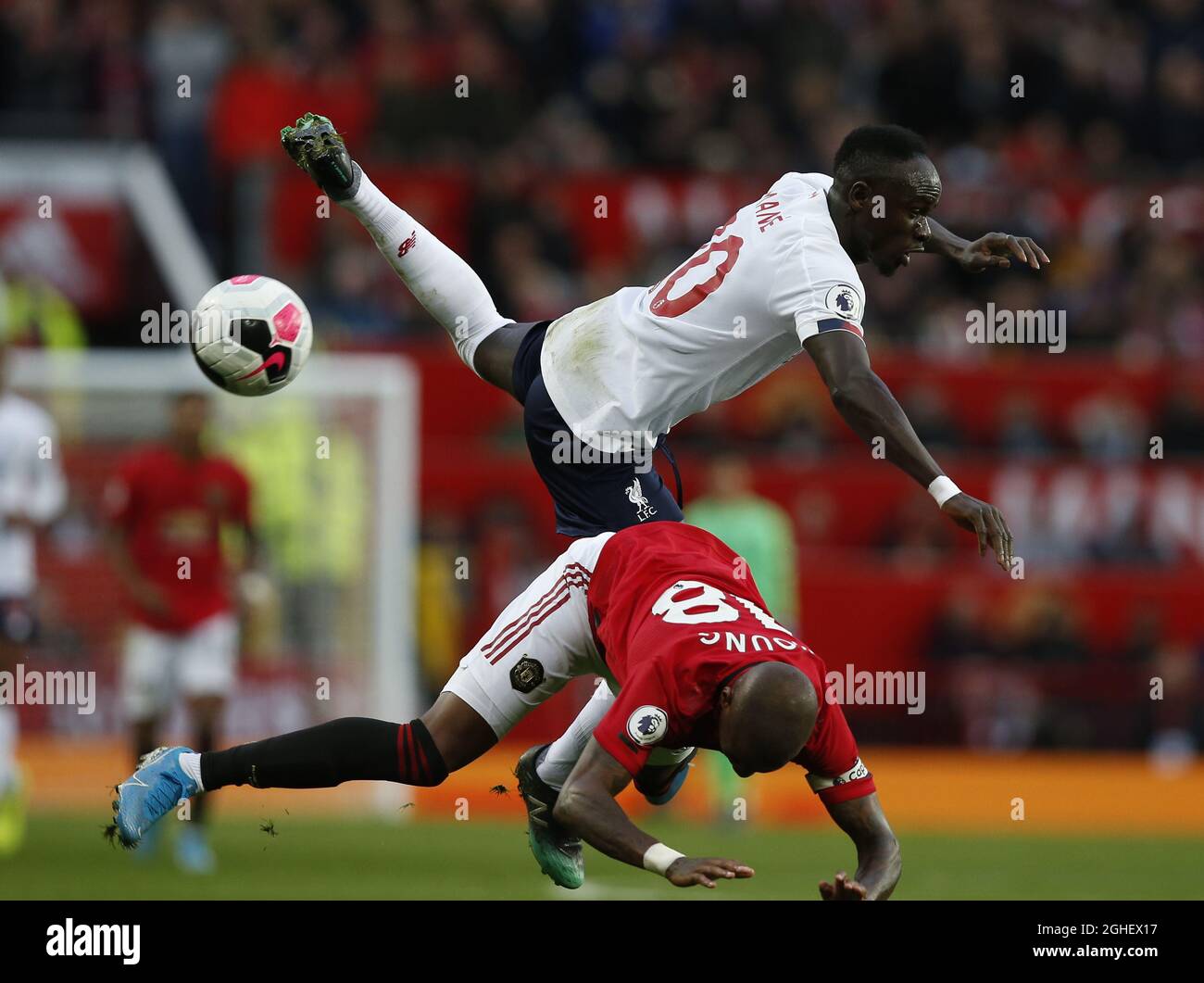 Sadio Mane of Liverpool tussles with Ashley Young of Manchester United ...