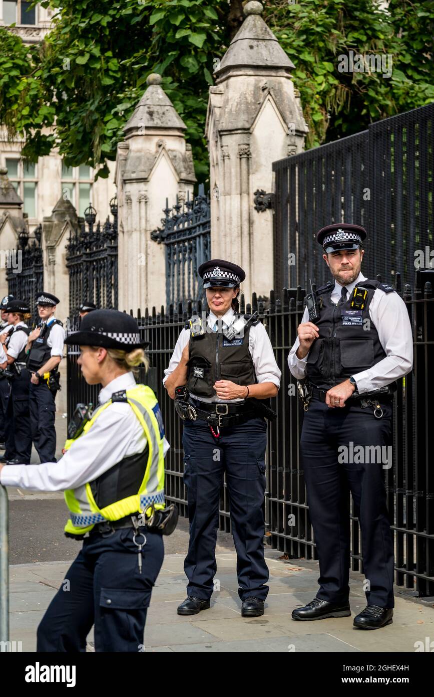 Police officers in front of the Houses of Parliament, Parliament Square ...