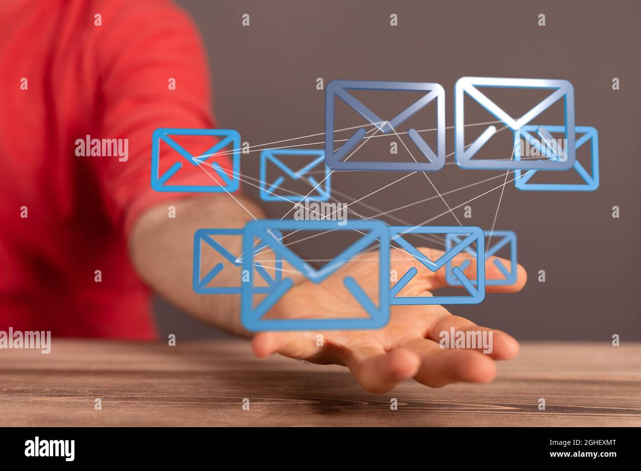 Closeup of a 3D rendered hologram of email icons hovering over a man's ...