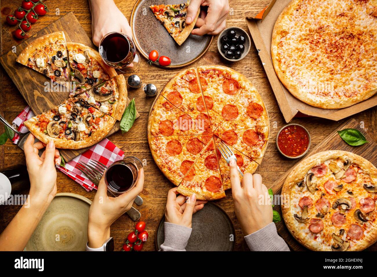 Family or friends pizza party. Flat-lay of people eating different ...