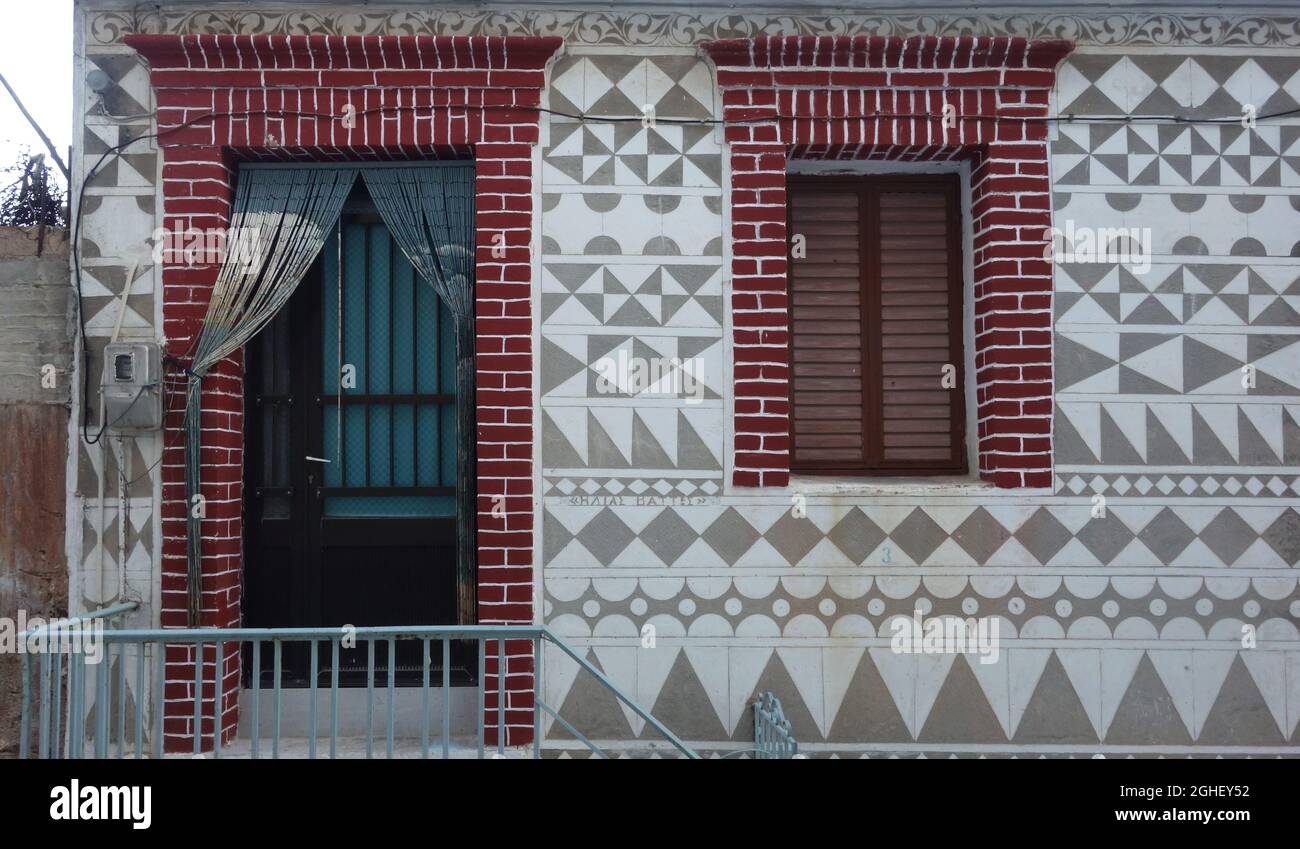 facade of a traditional stone house. The wall has special tiles on it ...