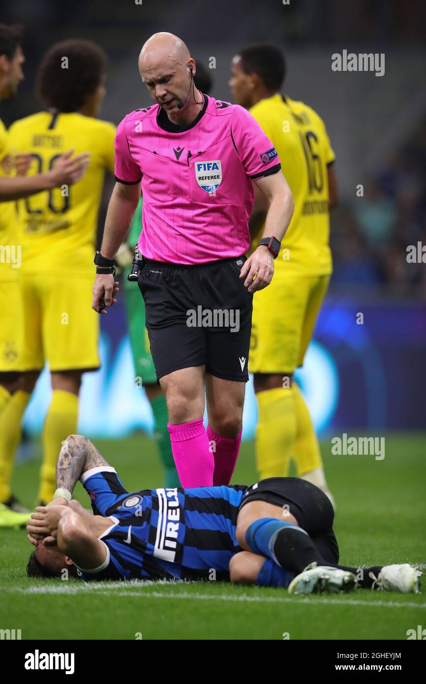 The referee Anthony Taylor checks on Lautaro Martinez of Inter after ...