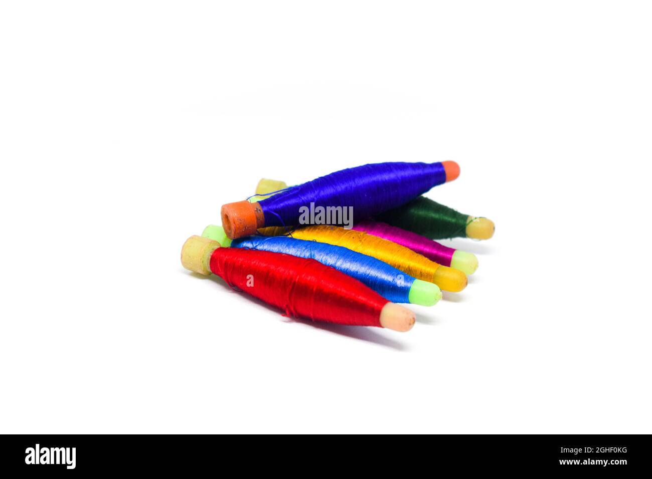 Closeup shot of colorful threads on a white background Stock Photo - Alamy