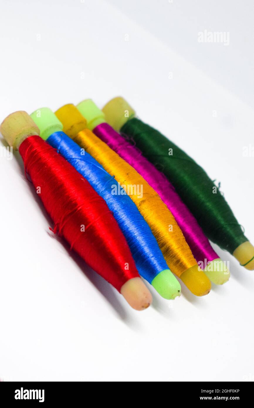 Vertical shot of colorful threads on a white background Stock Photo - Alamy