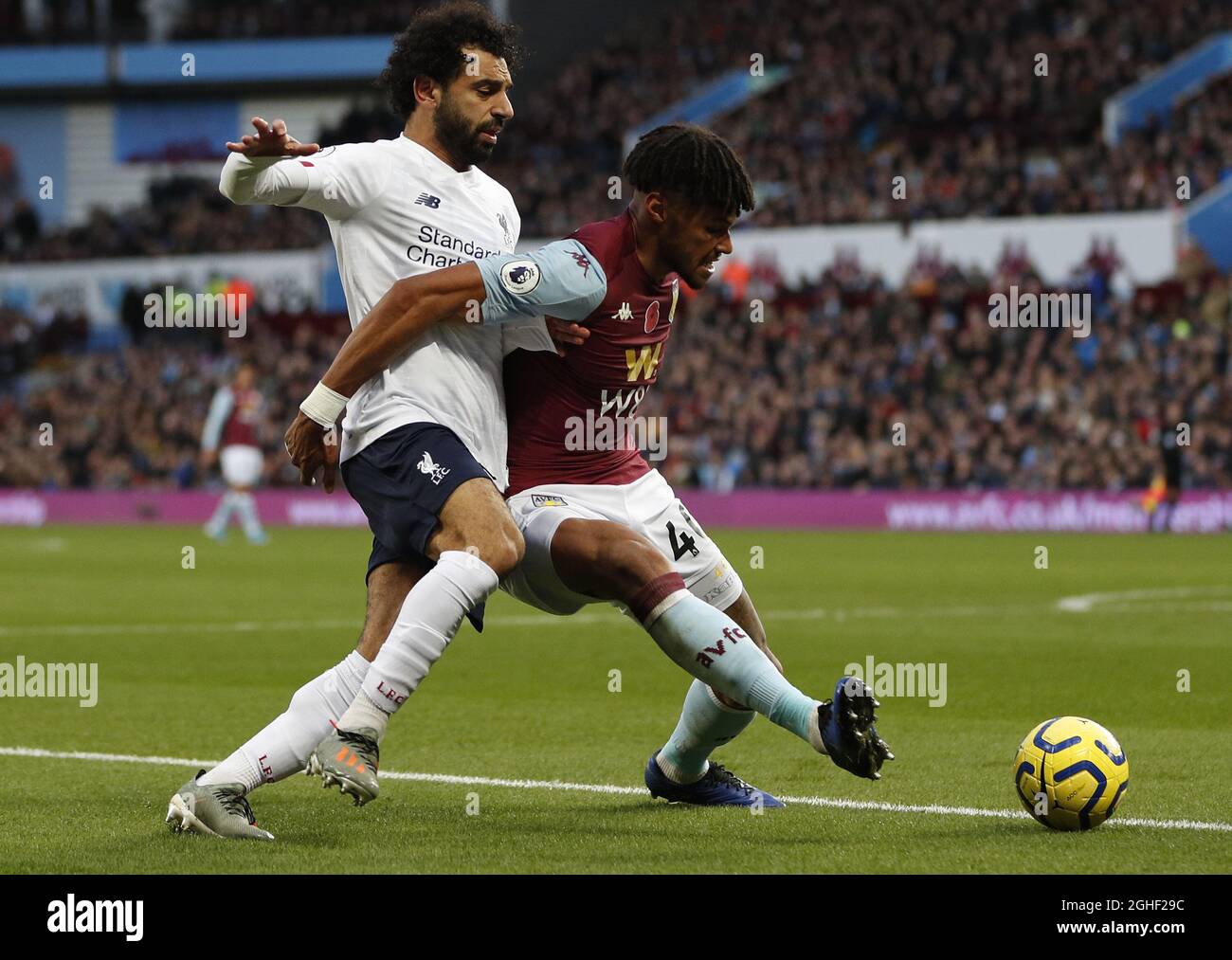 Tyrone Mings of Aston Villa holds off Mohamed Sarah of Liverpool during ...