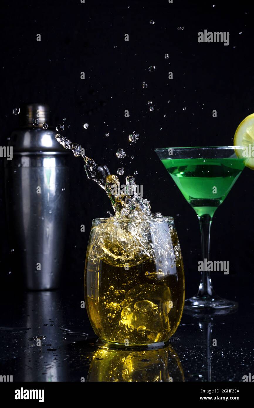 Vertical shot of alcoholic beverages on a black background with ...