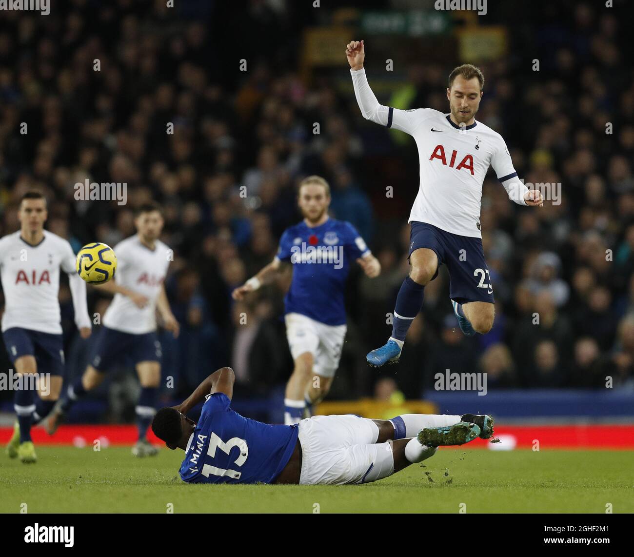 Christian Eriksen of Tottenham leaps over Yerry Mina of Everton during ...