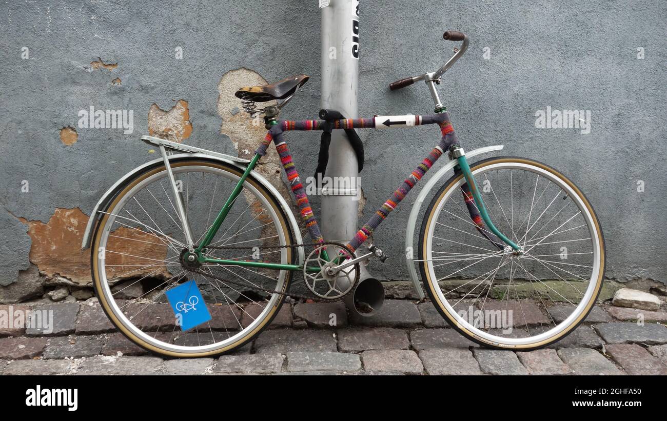 old bicycle wrapped in sewn colorful wool, resting on a wall, Tallinn, Estonia Stock Photo - Alamy