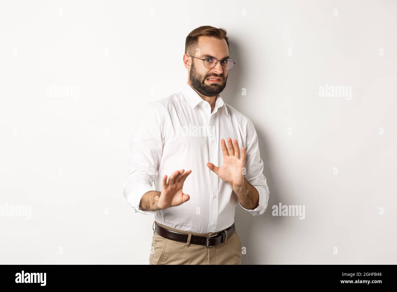 Disgusted businessman rejecting something bad, cringe from aversion ...