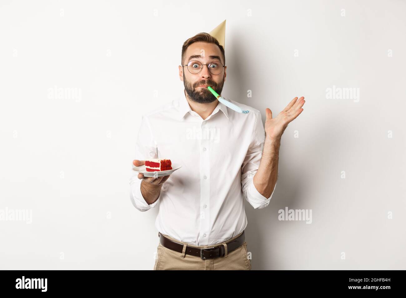 Holidays and celebration. Cheerful man enjoying birthday, blowing party ...