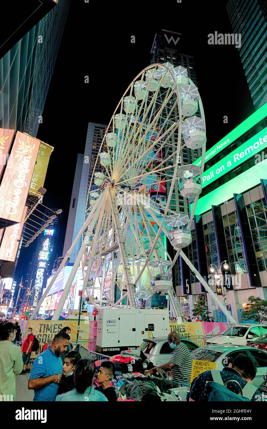 Times Square Wheel, a 110-foot-tall amusement, is a temporary tourist ...