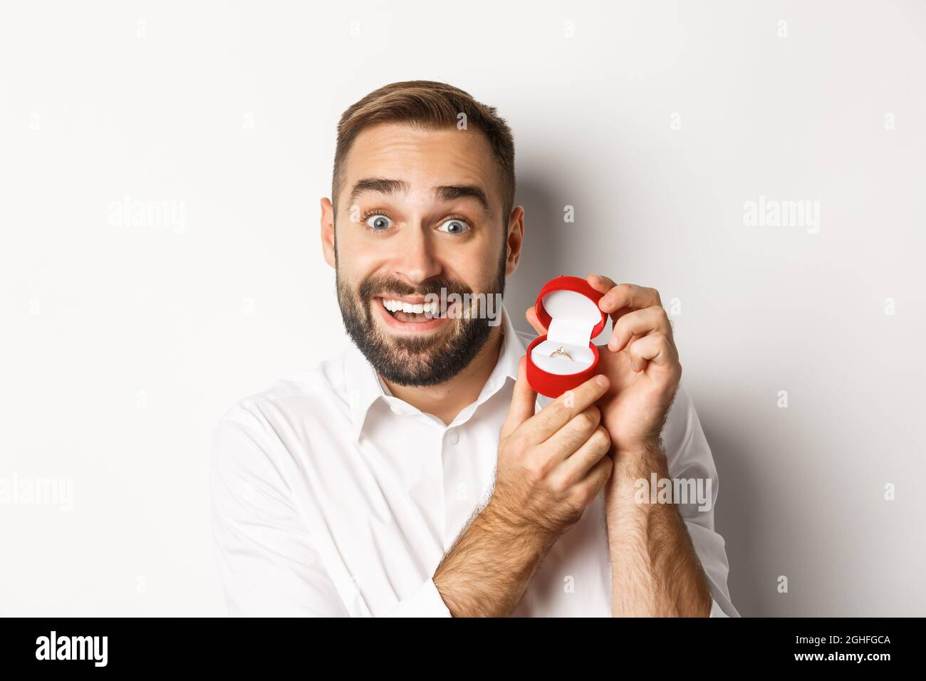 Close-up of handsome guy making proposal, looking hopeful and showing ...