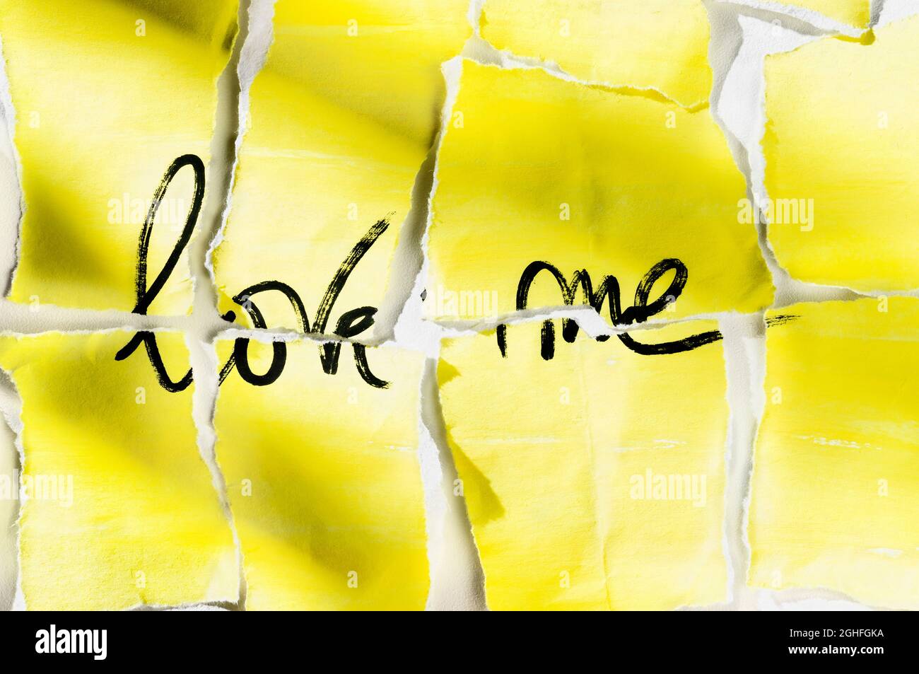 Yellow ripped paper with words LOVE ME on white background ,handwritten ...