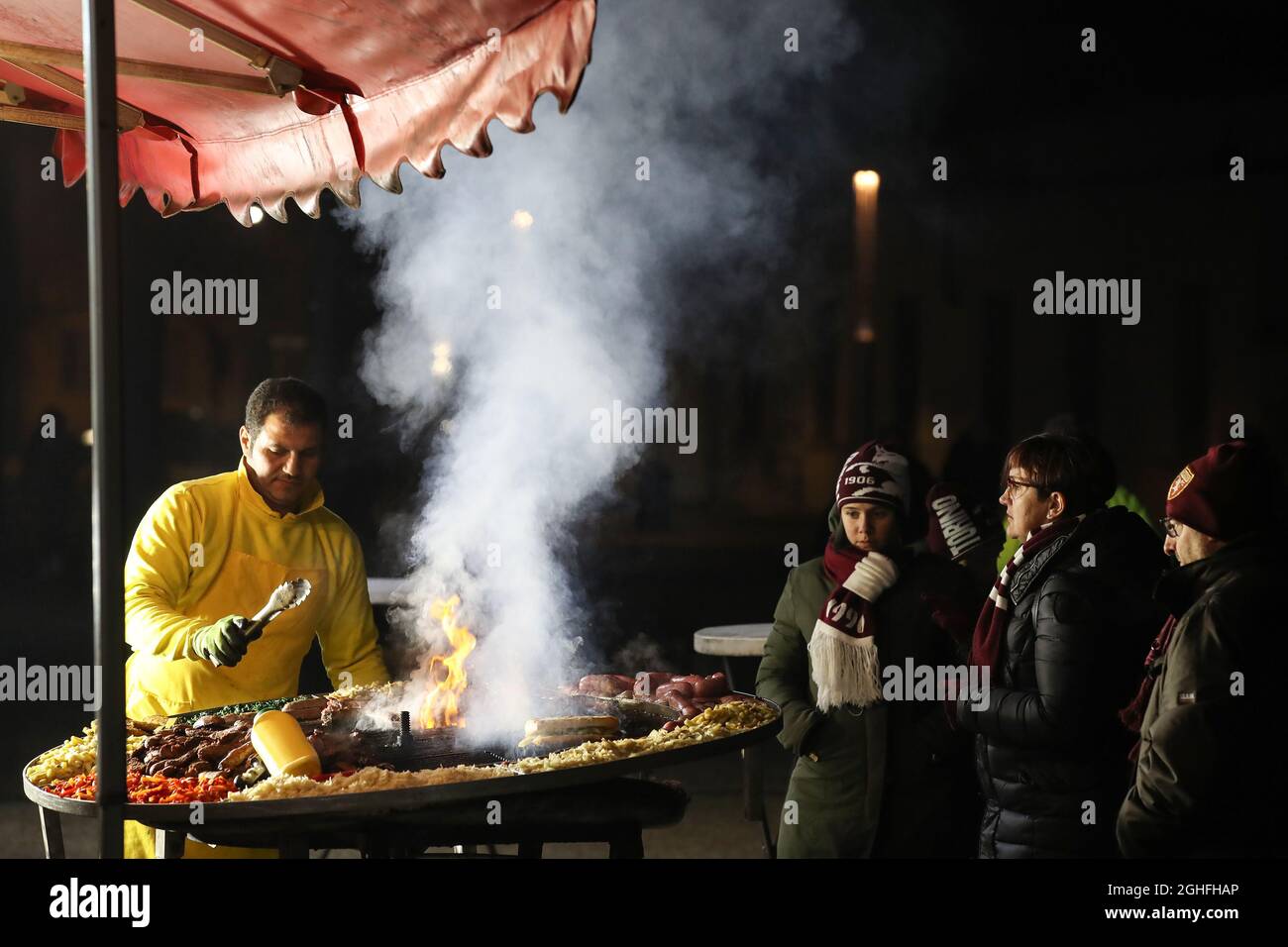 Street vendors serve hot food to fans before the Coppa Italia match at ...
