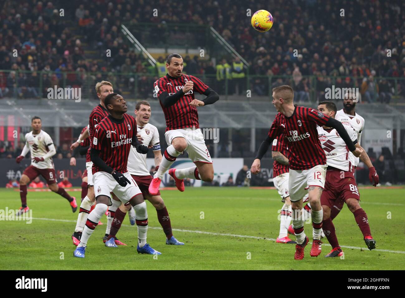 Zlatan Ibrahimovic of AC Milan heads clear from a corner kick during ...
