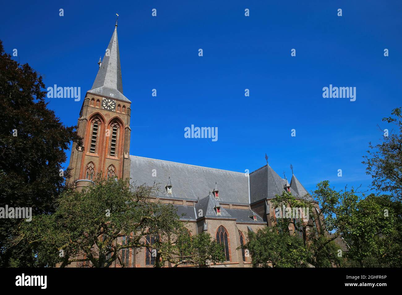 View on dutch neo gothic church from 18th century with green trees ...