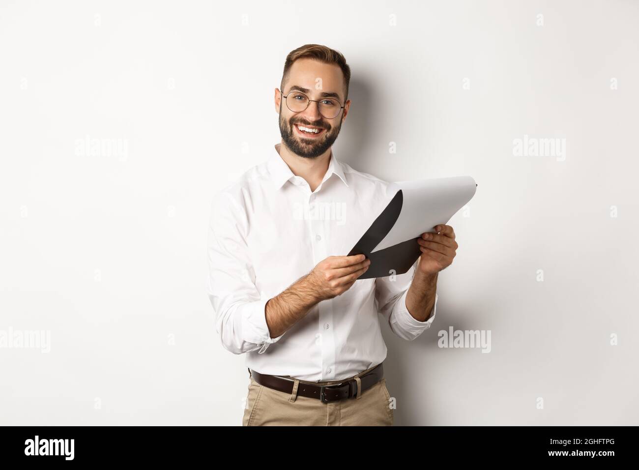 Employer looking satisfied at CV, reading document and smiling ...
