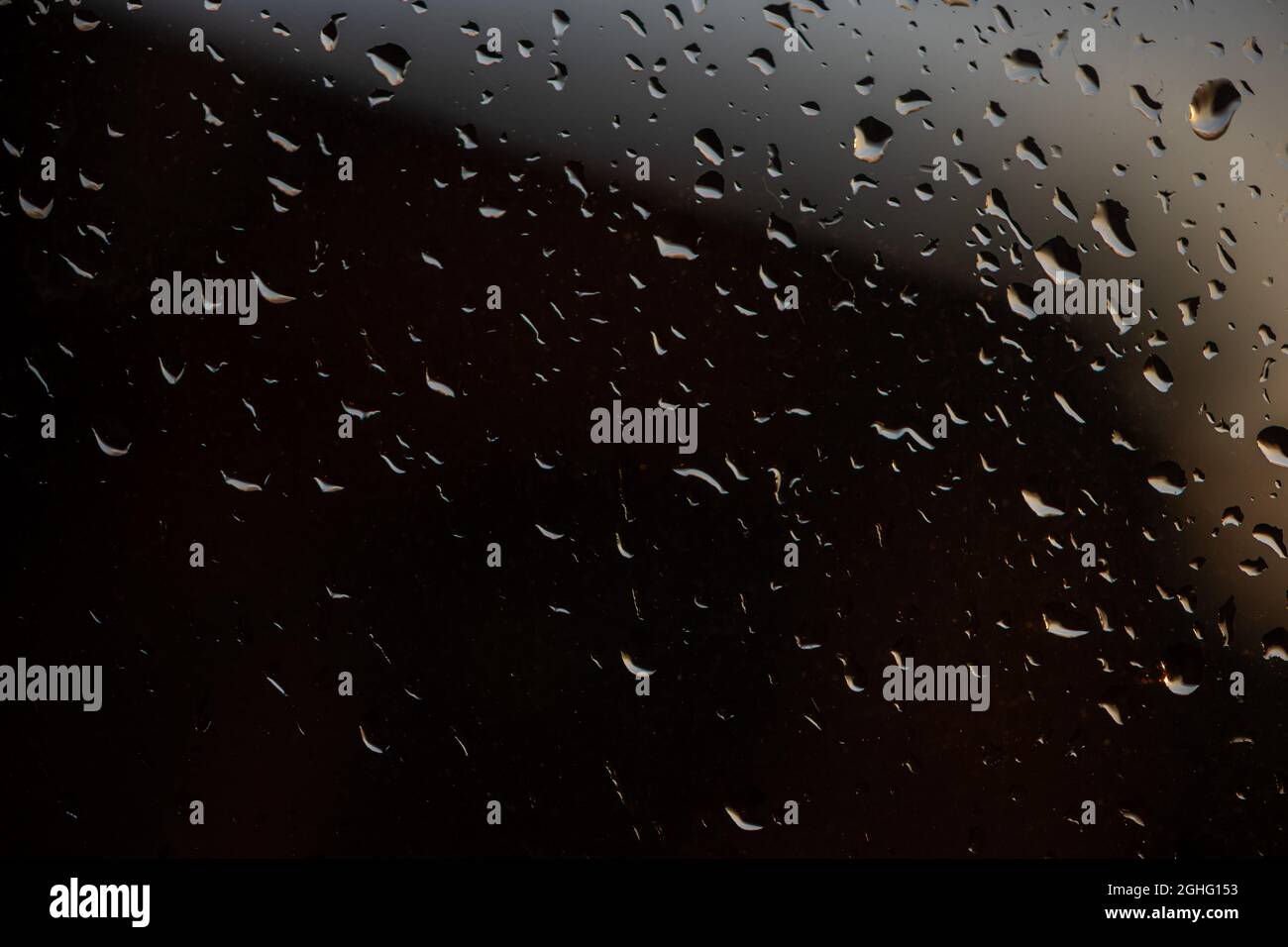 Raindrops on a window, sundown in the background Stock Photo - Alamy