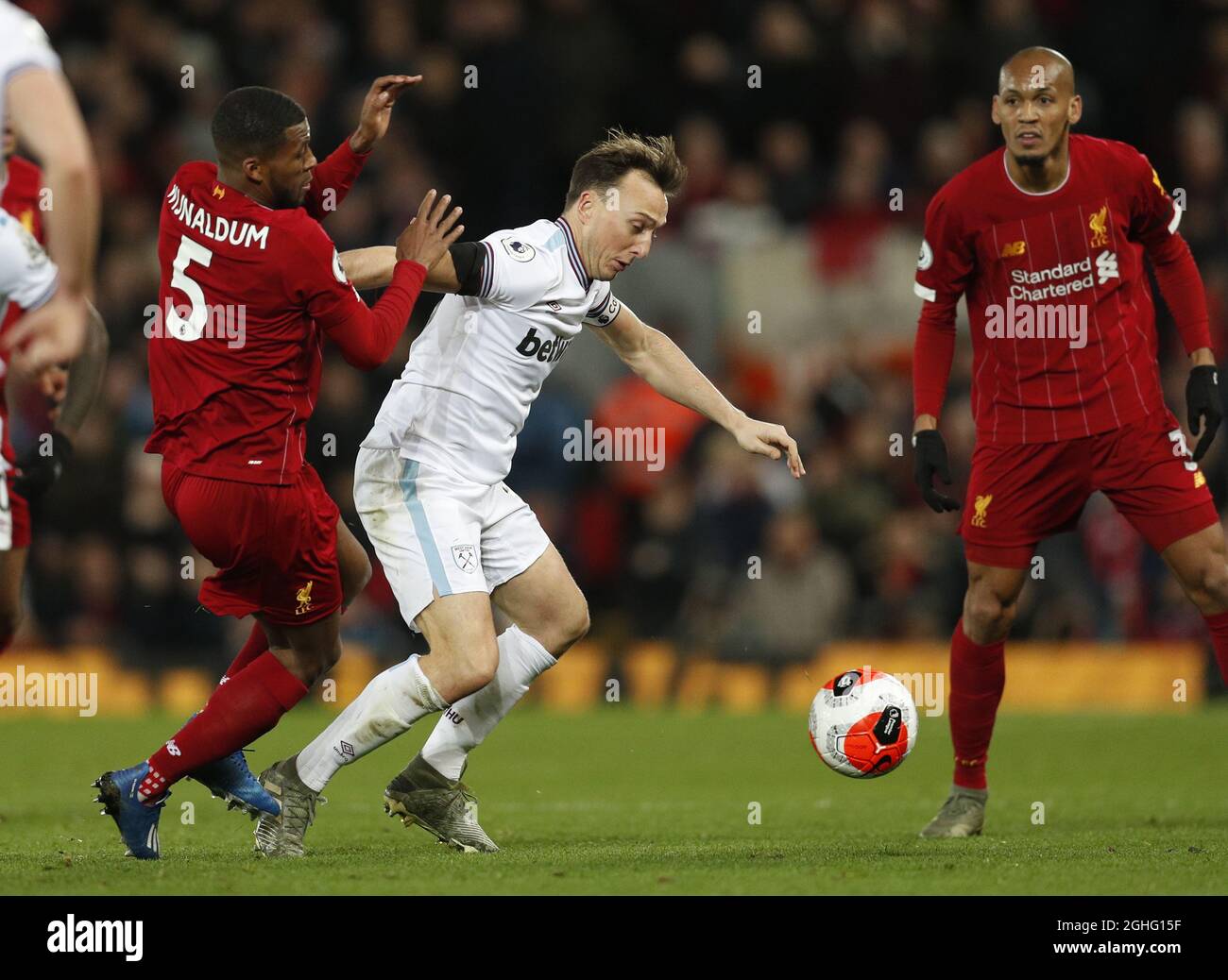 Georginio Wijnaldum of Liverpool tackles Mark Noble of West Ham United ...